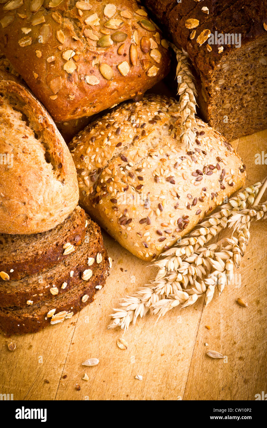 Collection of baked bread on wooden background Stock Photo - Alamy