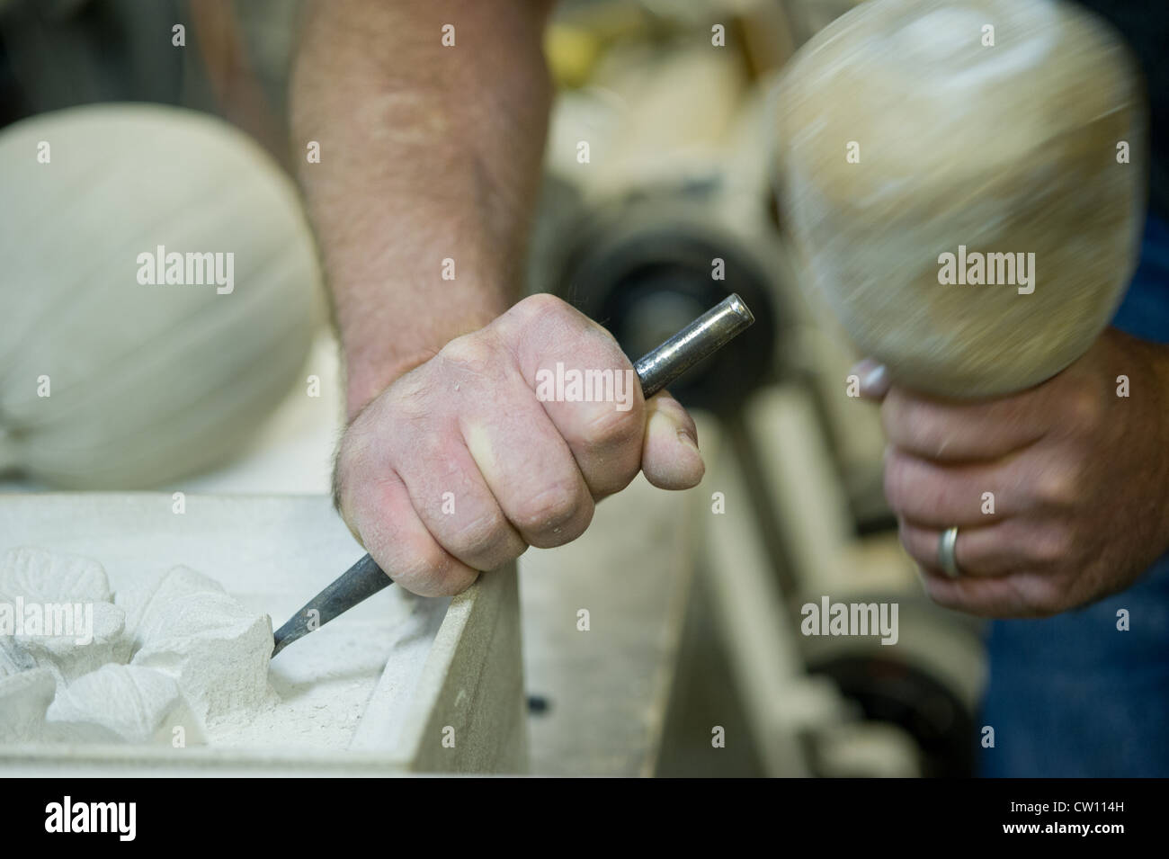 Stonecarver chiseling feature on sculpture Stock Photo - Alamy