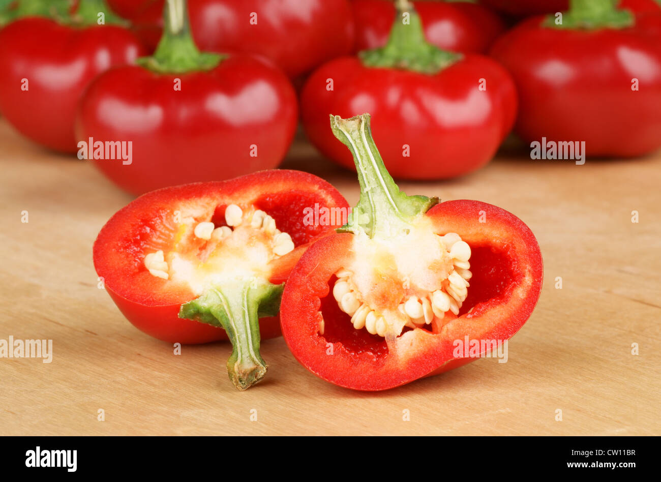 Sliced, round, red chili pepper over a wooden cutting board Stock Photo ...