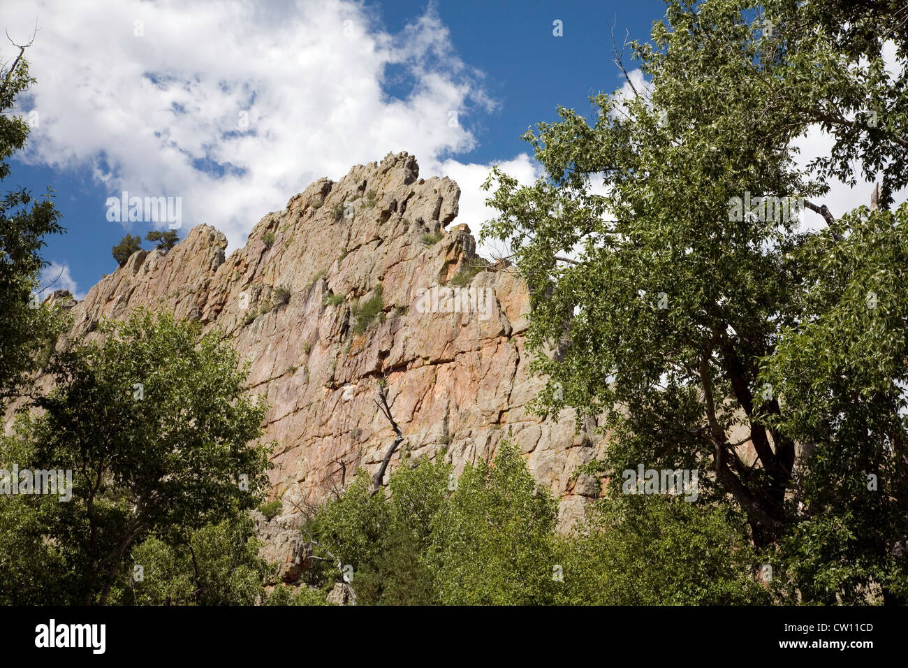 A reef of rocks frame a ranch in the Spanish Peaks Wilderness Area of ...