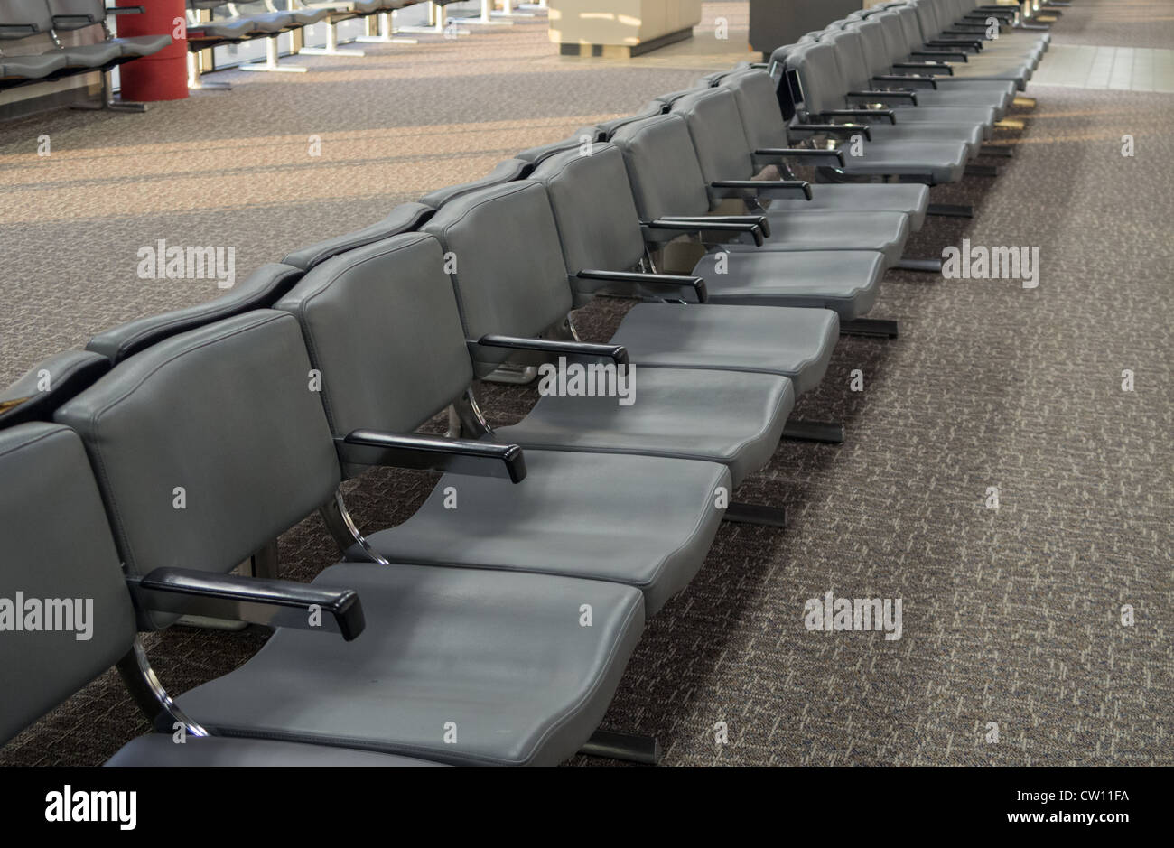 Airport terminal waiting area with chairs Stock Photo - Alamy