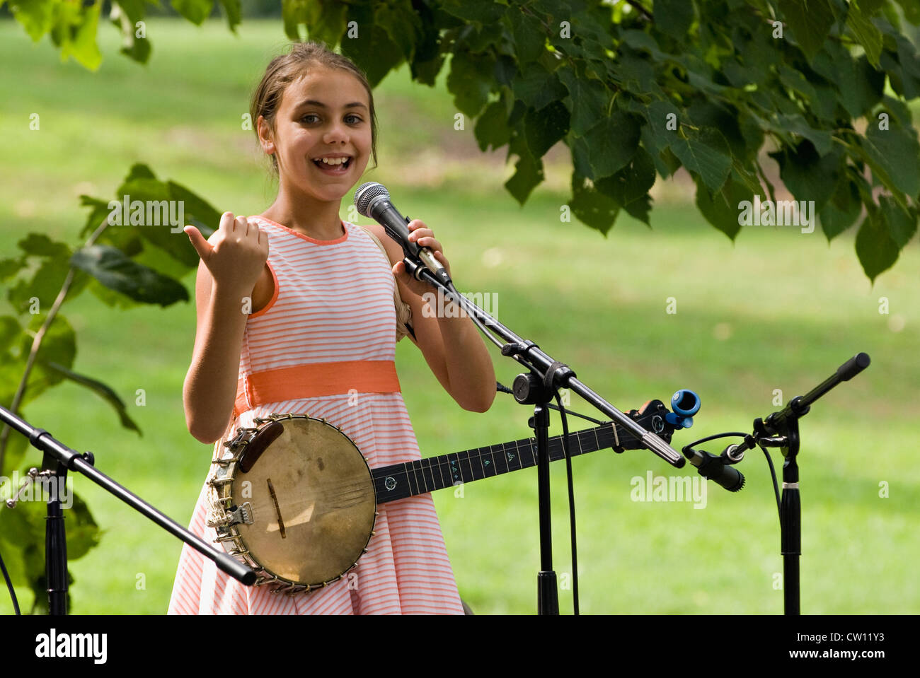Young Girl Playing Banjo with Barefoot Best Friends Performing at the ...