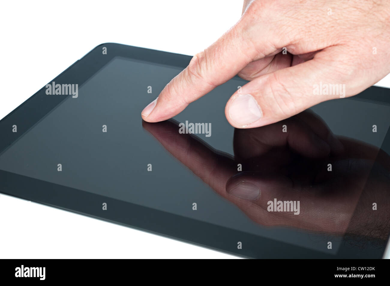 A man uses a touchpad tablet to gain wireless Internet access Stock ...