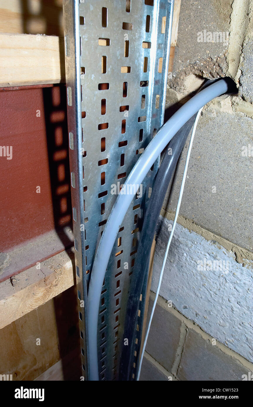 Water pipe going through partition wall Stock Photo - Alamy