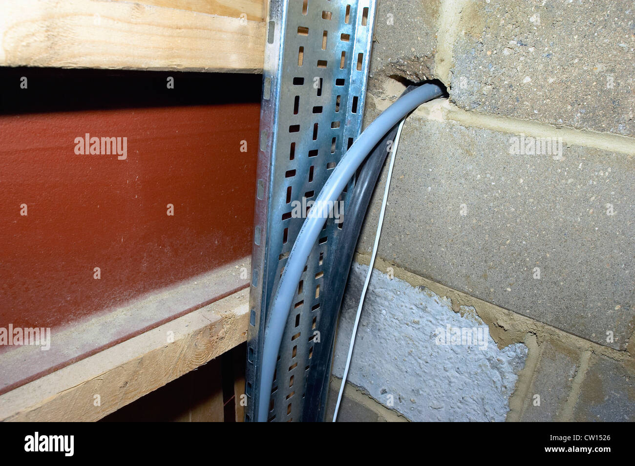 Water pipe going through partition wall Stock Photo - Alamy