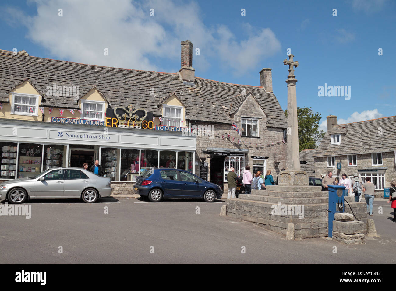 The National Trust shop and Market Cross in Corfe Castle, Dorset, UK ...
