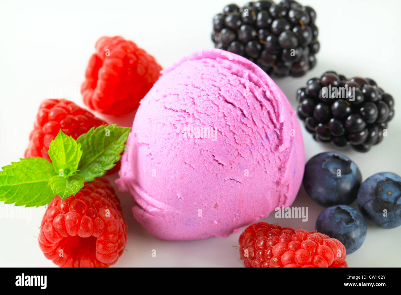 Scoop of fruit ice cream with fresh mixed berries Stock Photo - Alamy