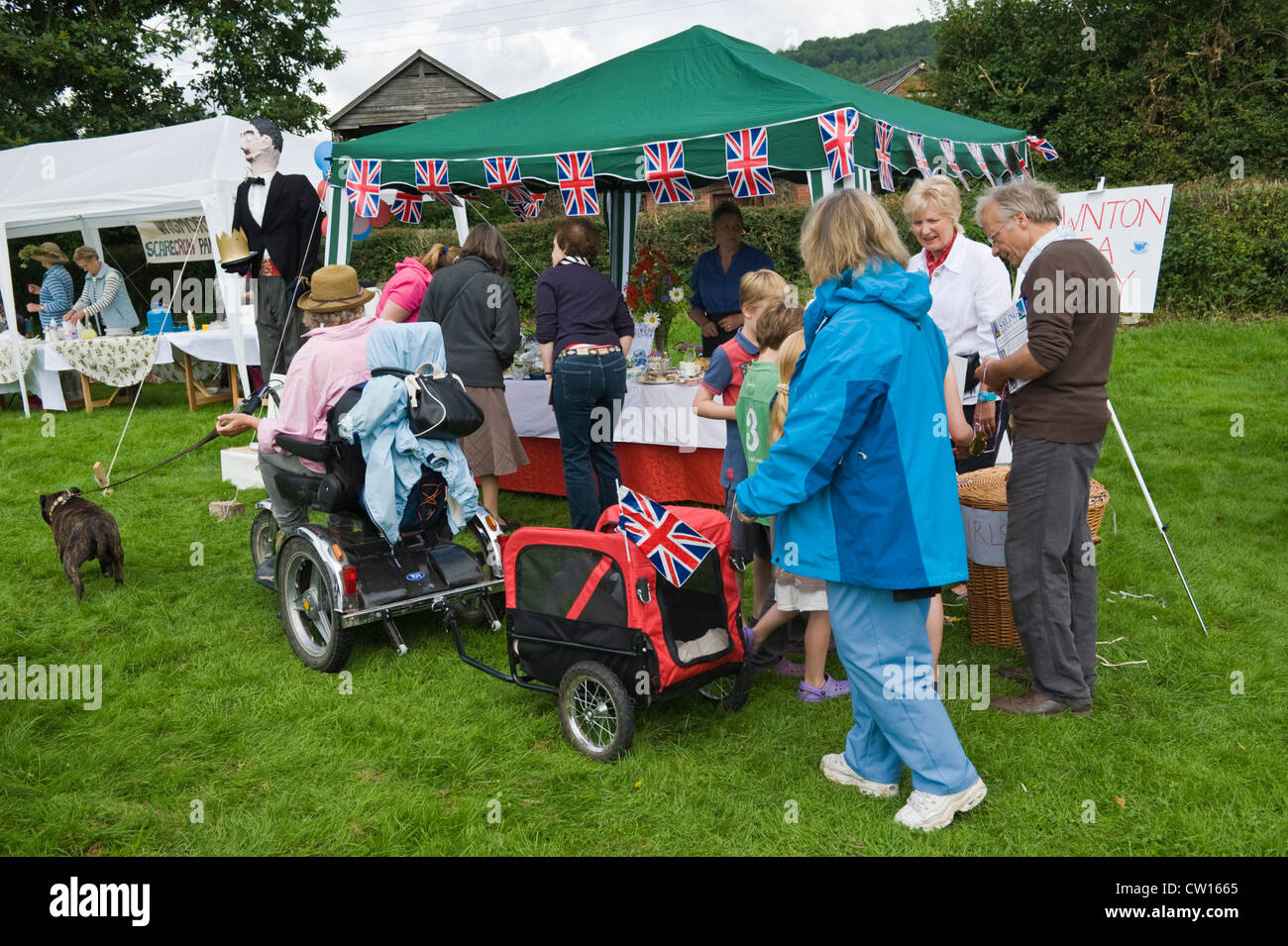 Visitors browse stalls at fete on Scarecrow Day in village of Brampton ...