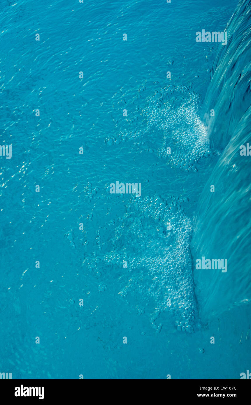 Cascading water in swimming pool. Early morning Stock Photo - Alamy