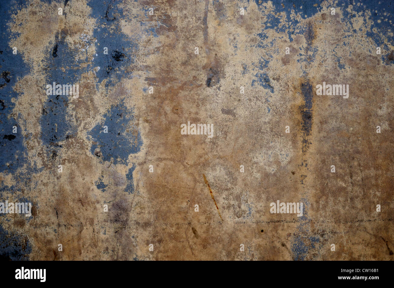 Decaying wall in blue, beige and brown colours. Grungy background for ...