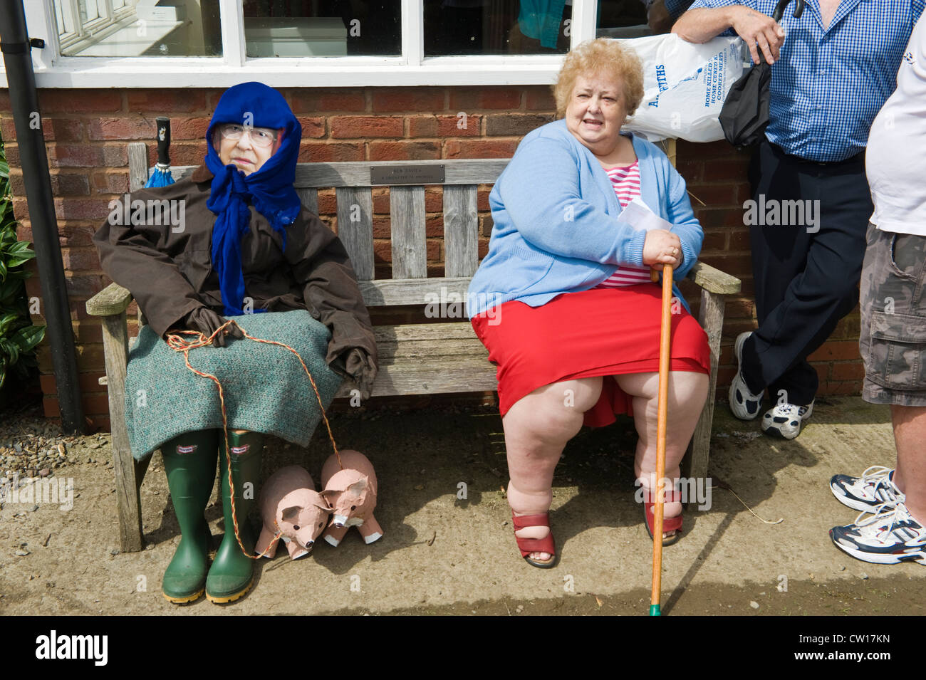Effigy of The Queen sat on bench with elderly lady during Scarecrow Day ...