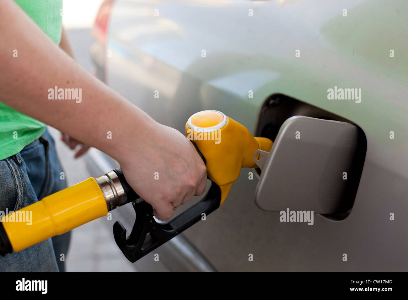 Driver pumping gasoline at the gas station, closeup Stock Photo - Alamy