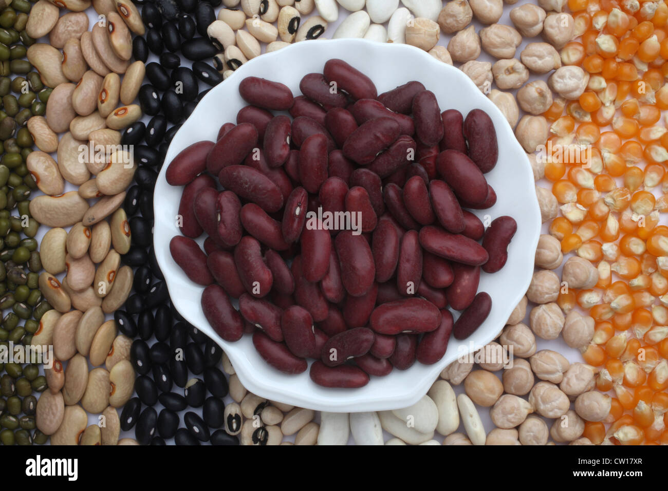 Ceramic plate with red beans over seeds and grains background Stock ...