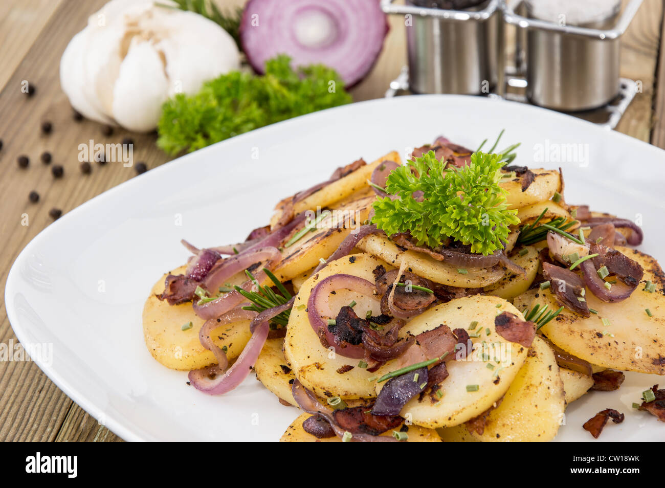 Portion of fried Potatoes with raw ingredients in the background Stock ...