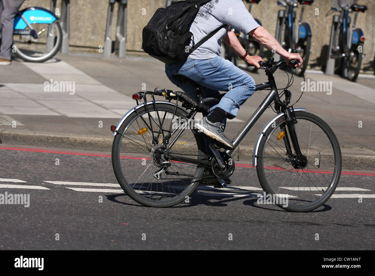A cycle being ridden along a road in London Stock Photo - Alamy