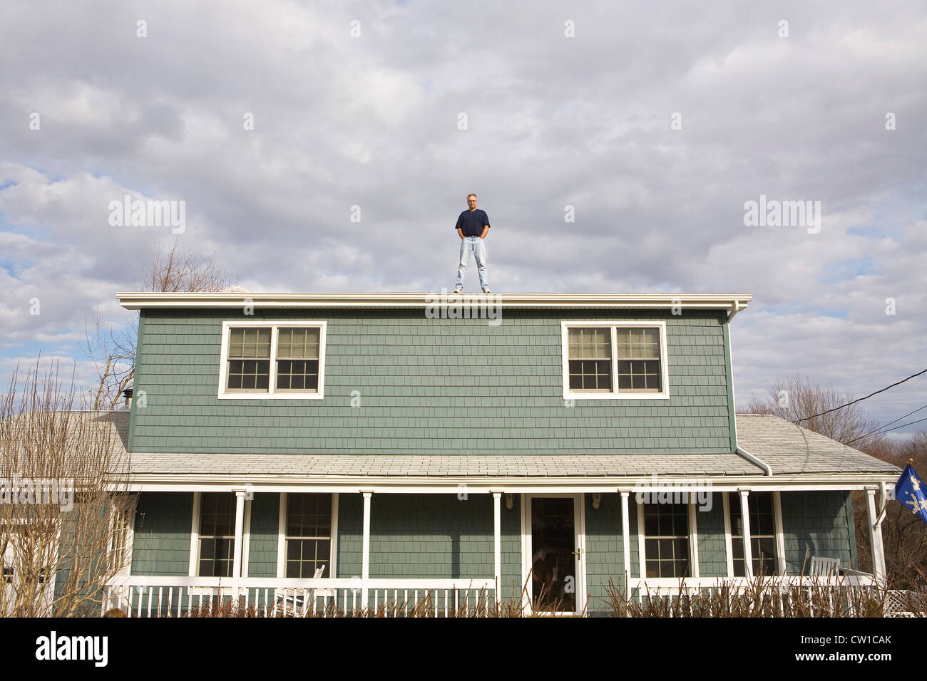 Man on Roof of Home Stock Photo - Alamy