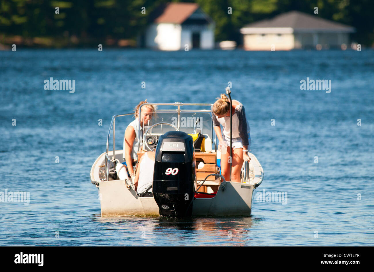 Three girls stranded on a motor boat Stock Photo - Alamy
