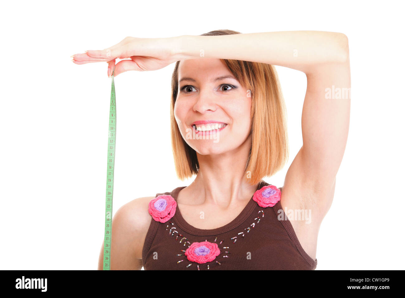 Beautiful young caucasian woman measuring her body with tape, isolated ...