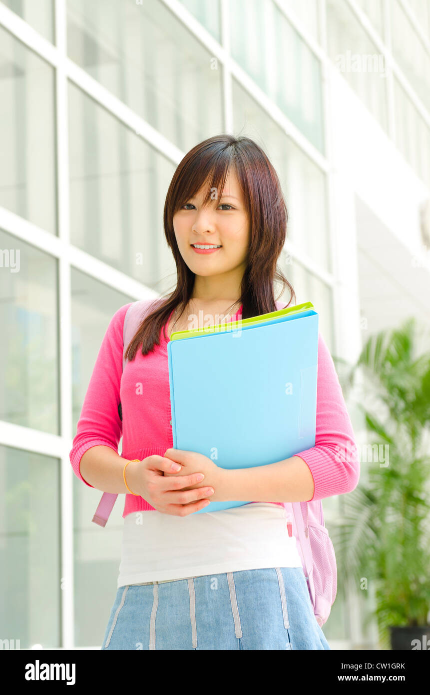 College Student standing outside college building Stock Photo - Alamy