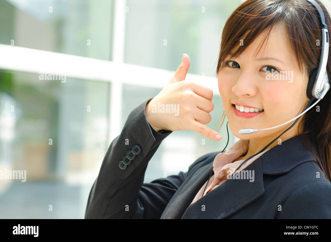 Friendly Customer Representative with headset Stock Photo - Alamy
