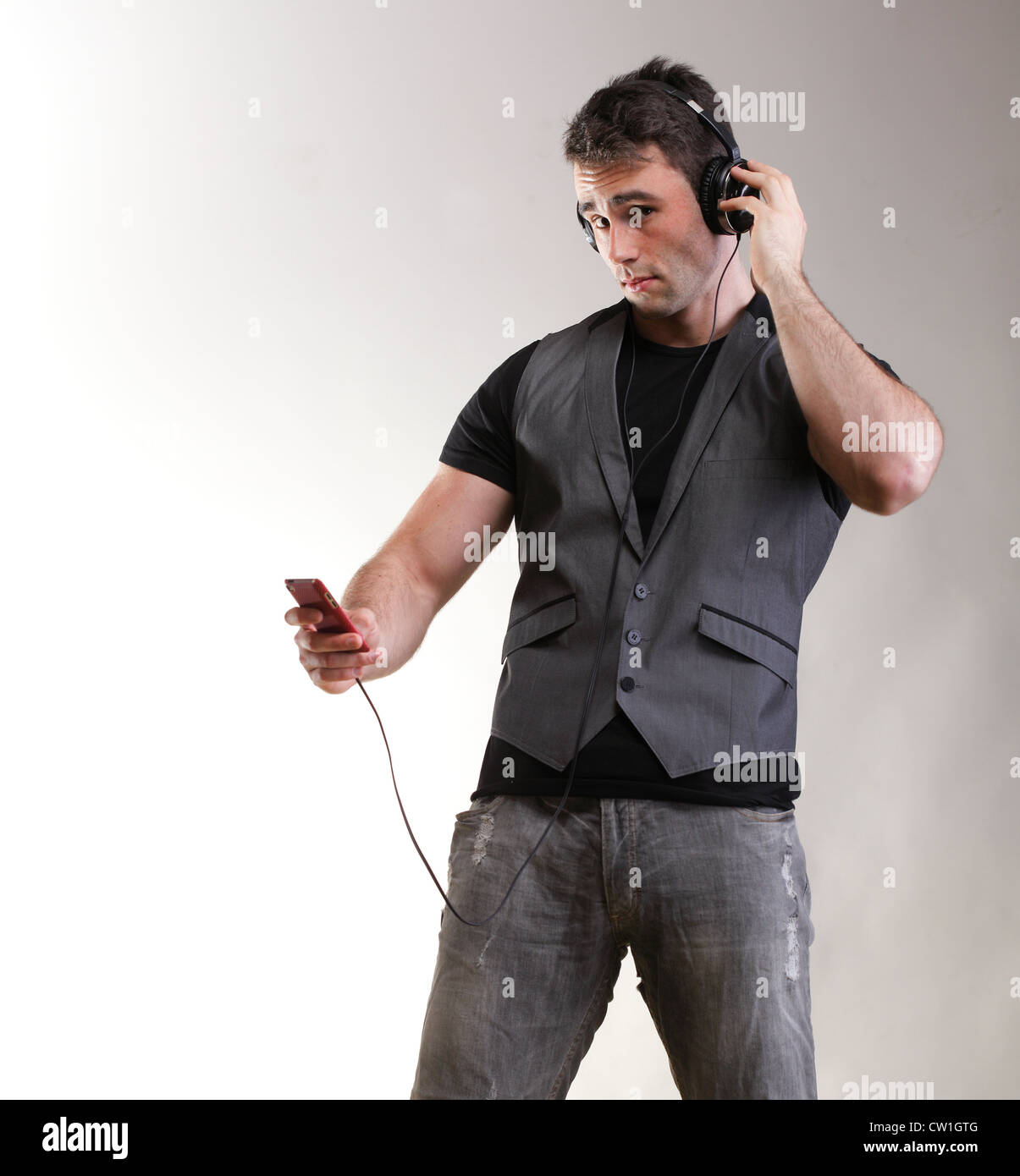 Full length portrait school boy with phone isolated on white. Music or ...