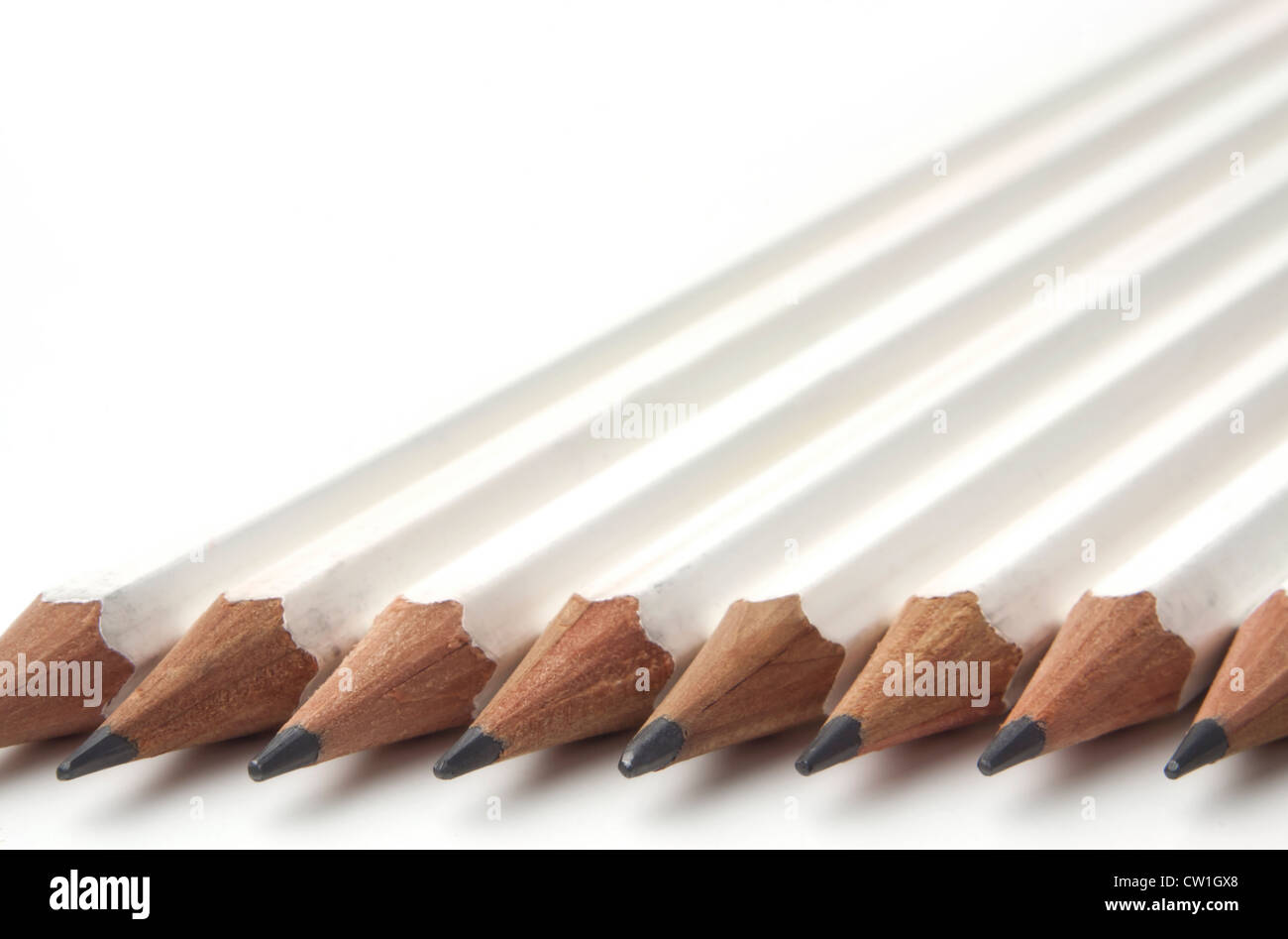 Diagonal row of white pencils isolated on white background with copy ...