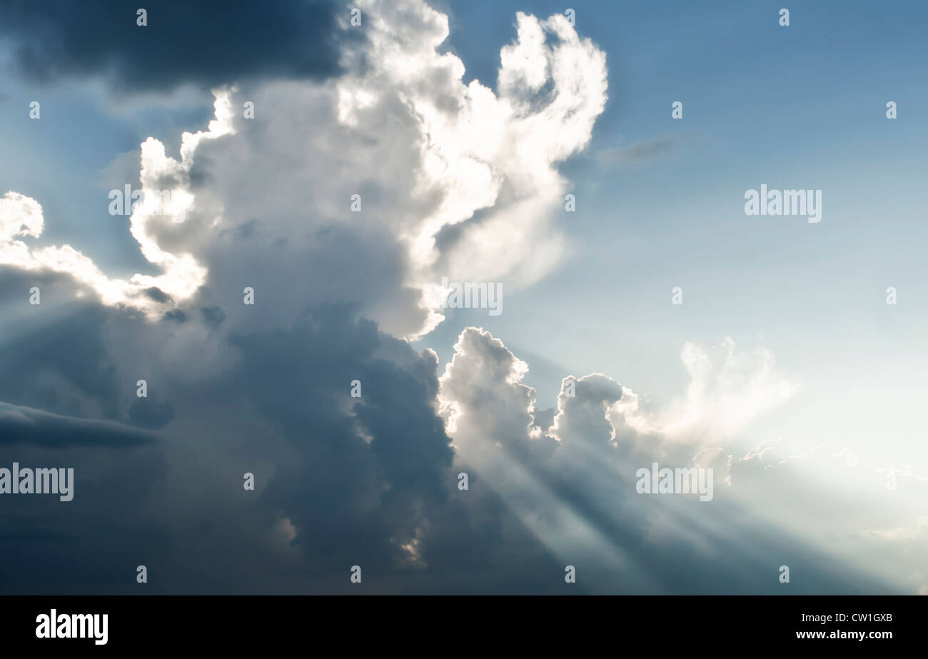 Beautiful cloudy blue sky scene with strong vibrant sun rays or beams ...