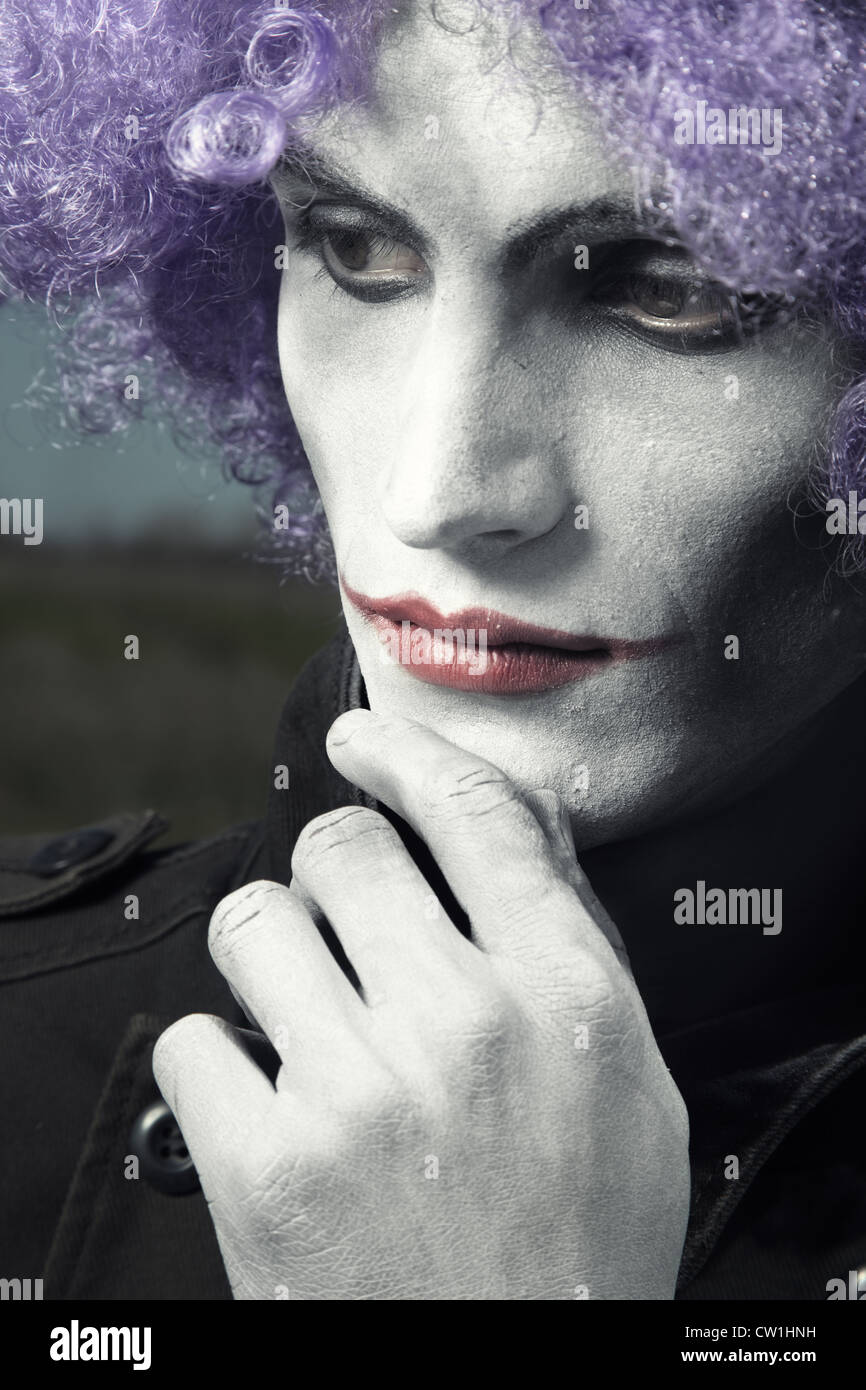 Single sad clown with theatrical makeup and wig. Vertical photo with ...