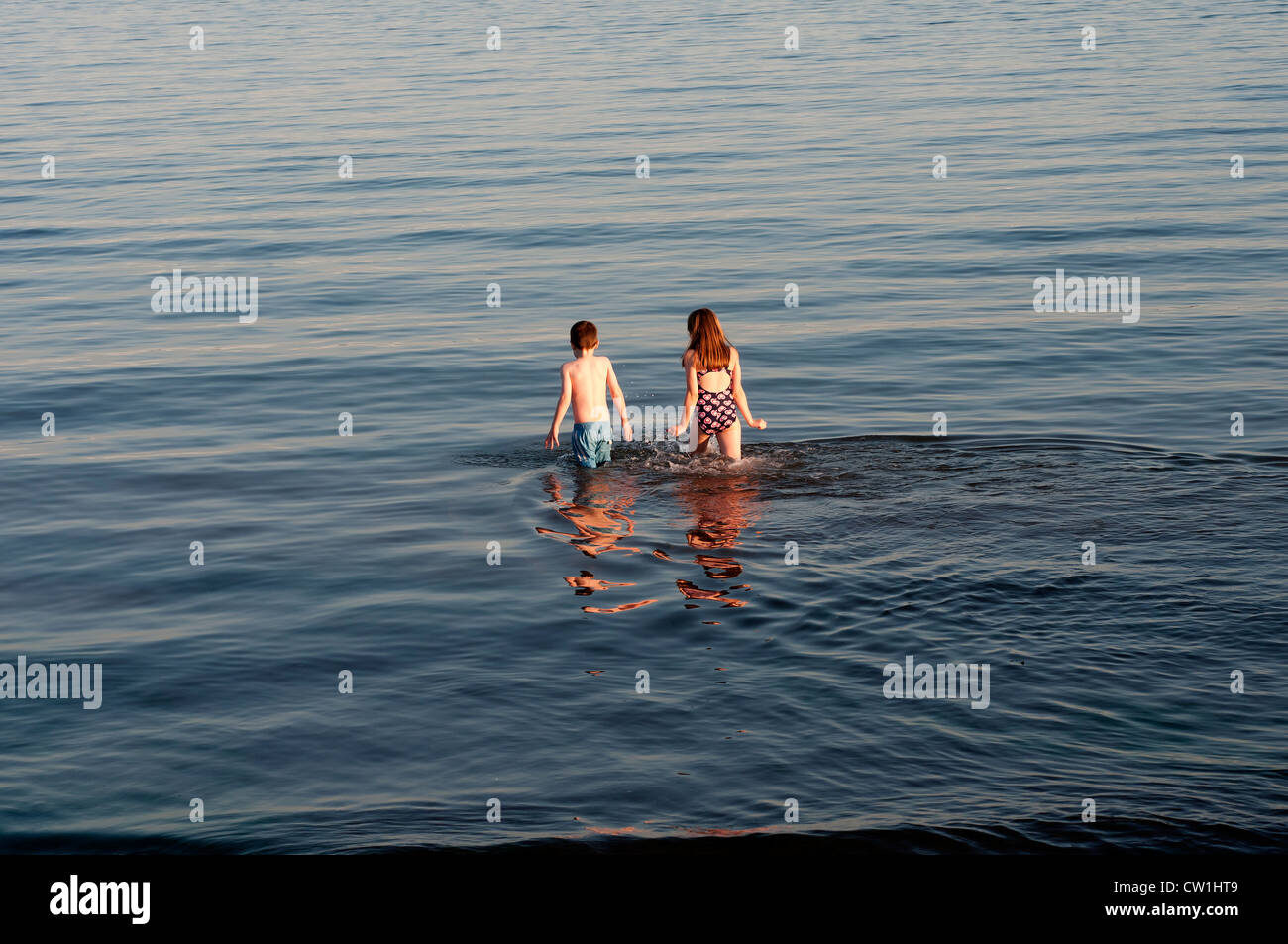 children wading into the sea Stock Photo - Alamy