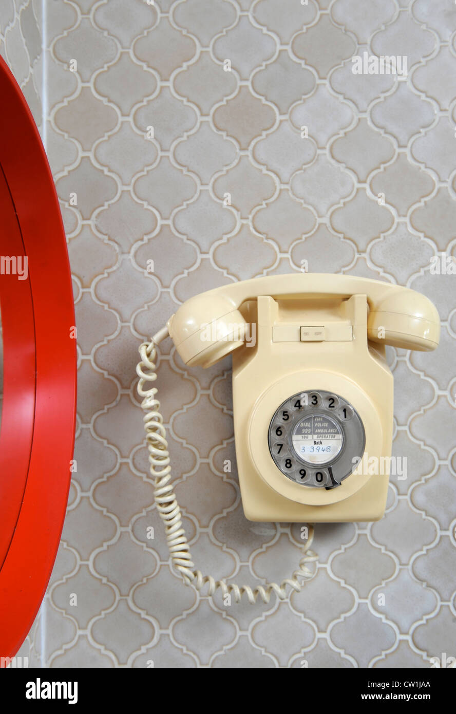 A classic wall mounted bakelite telephone in a 1970's style house which ...
