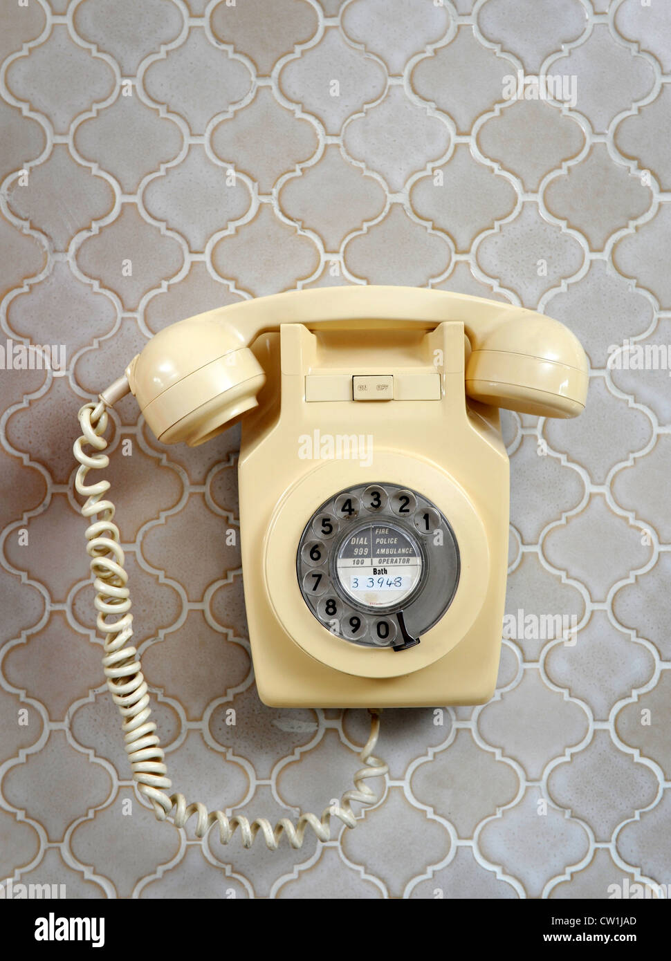 A classic wall mounted bakelite telephone in a 1970's style house which ...