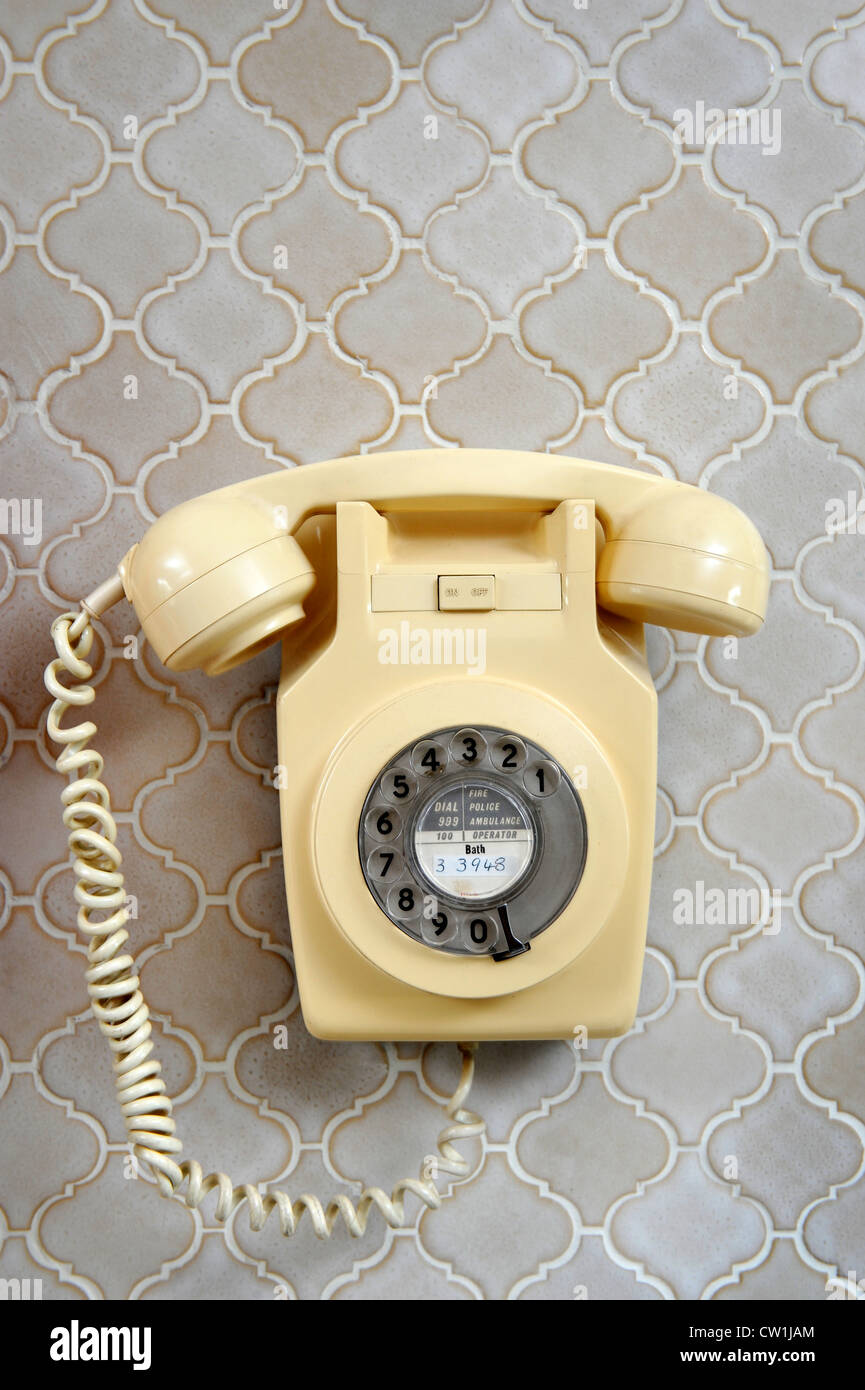 A classic wall mounted bakelite telephone in a 1970's style house which ...