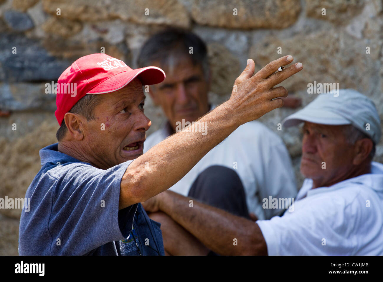 Greek men meeting and having a conversation at Lindos village near the ...