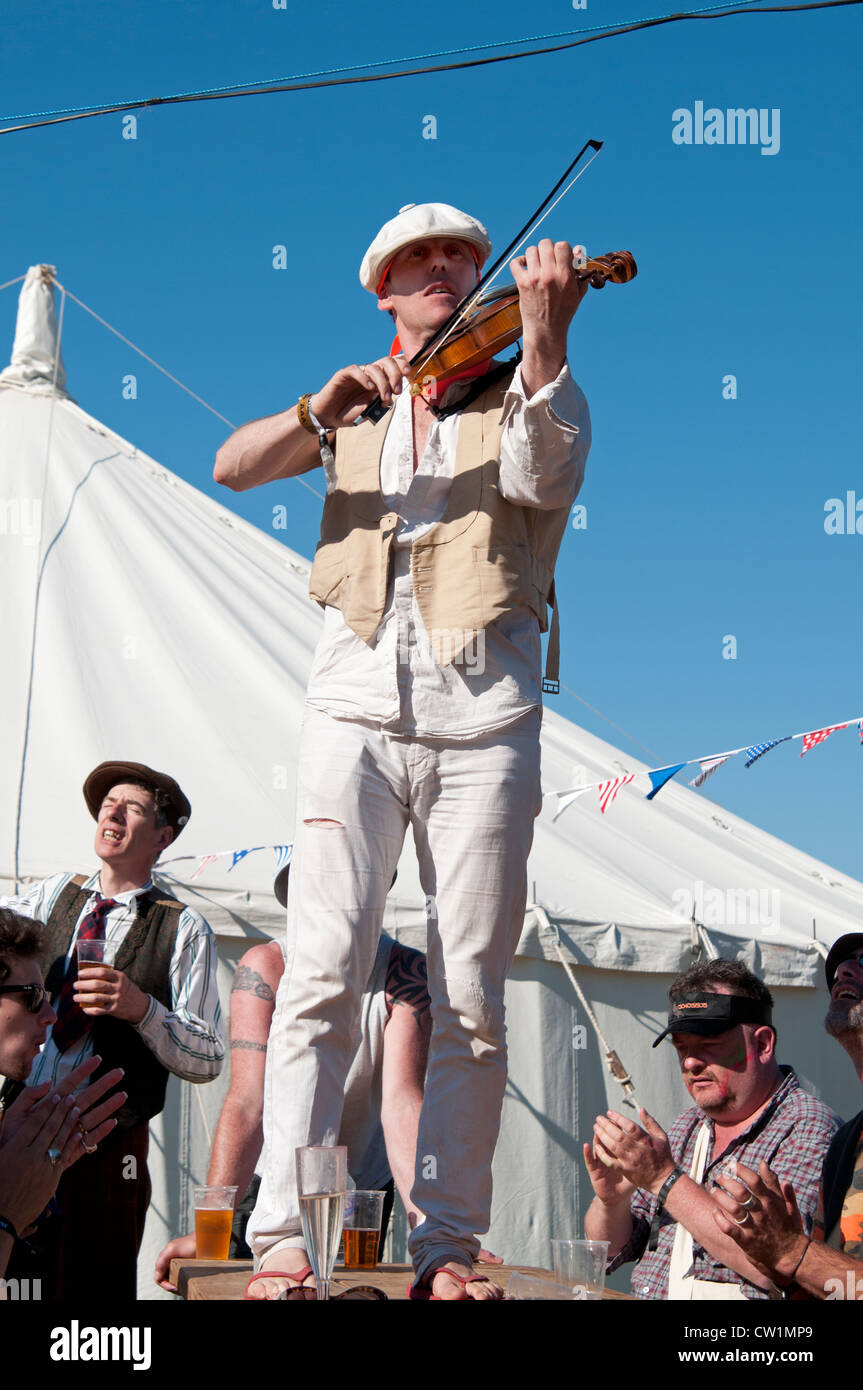 Fiddle player standing on a table playing at the Port Eliot literary ...