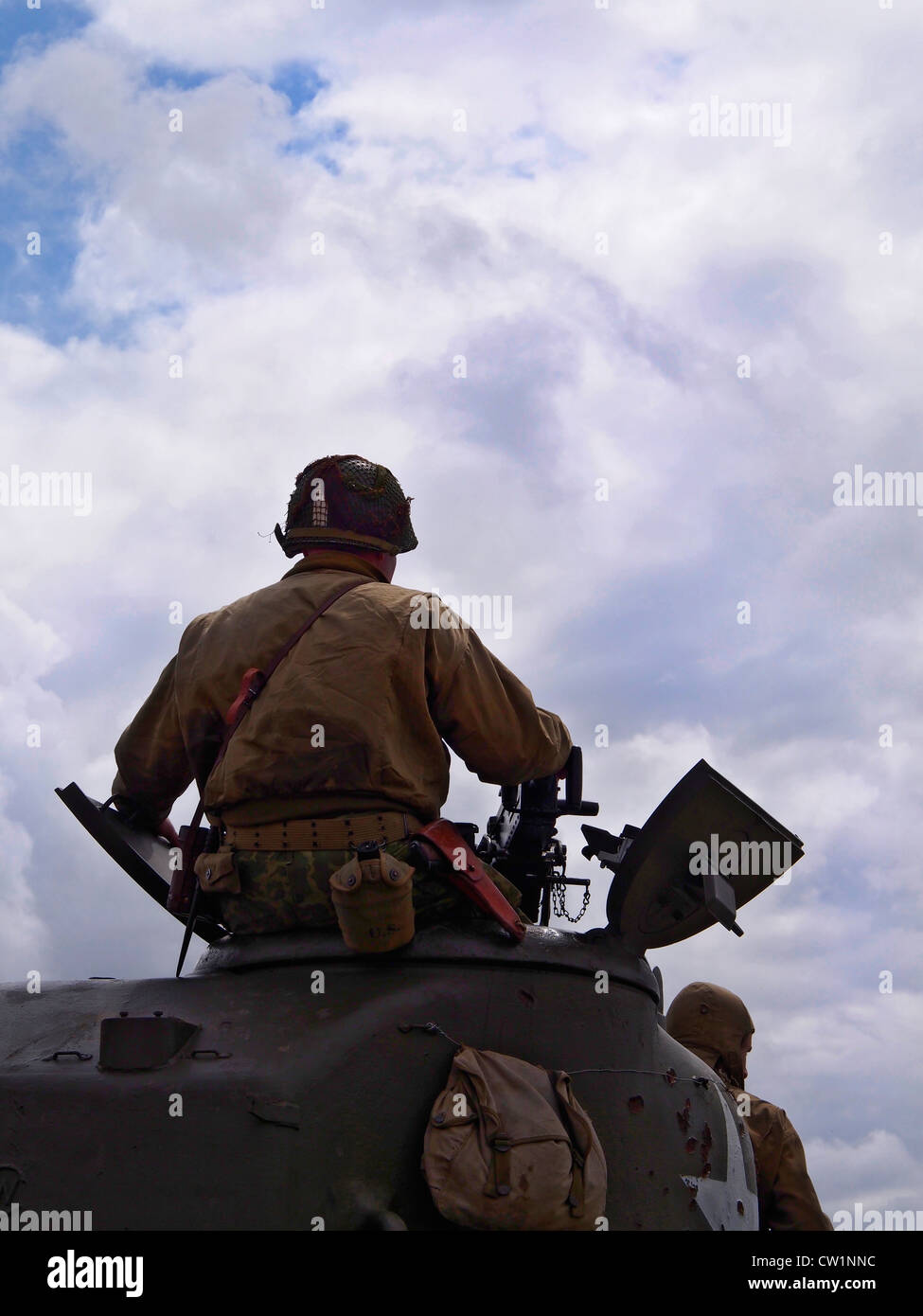 Portrait close up of tank commander aiming machine gun on American ...