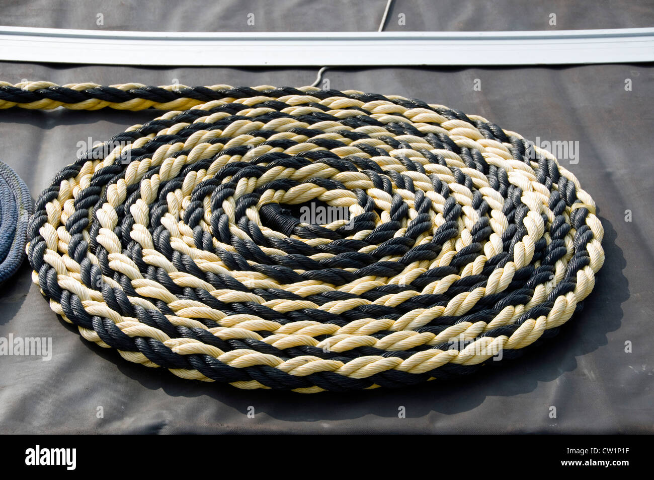 Yellow and black coiled rope Stock Photo - Alamy