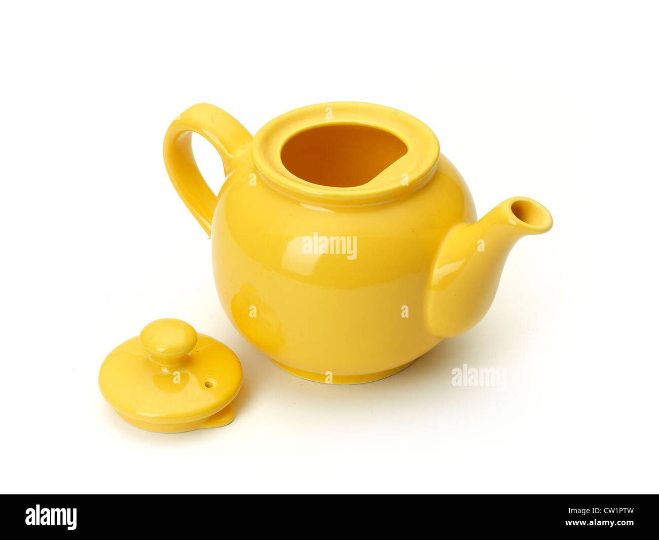 yellow tea pot on white background Stock Photo - Alamy
