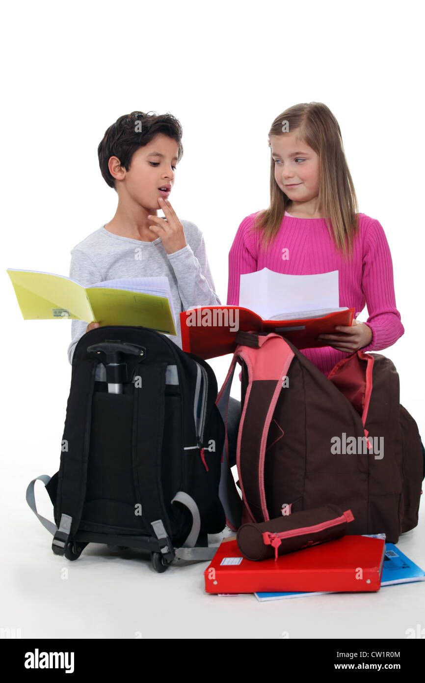 Schoolchildren comparing homework Stock Photo - Alamy