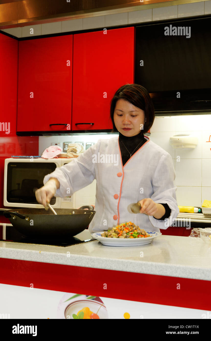 A young lady chef at a chinese cooking class Stock Photo - Alamy