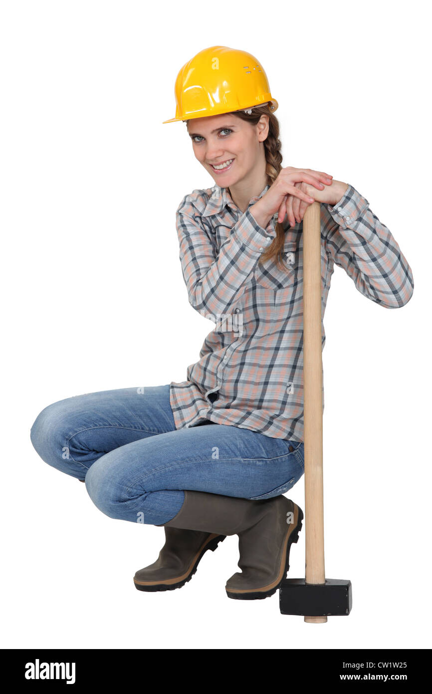craftswoman holding a huge hammer Stock Photo - Alamy
