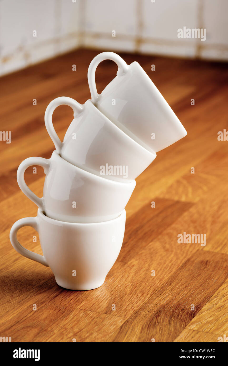Stack of four white china coffee cups Stock Photo - Alamy