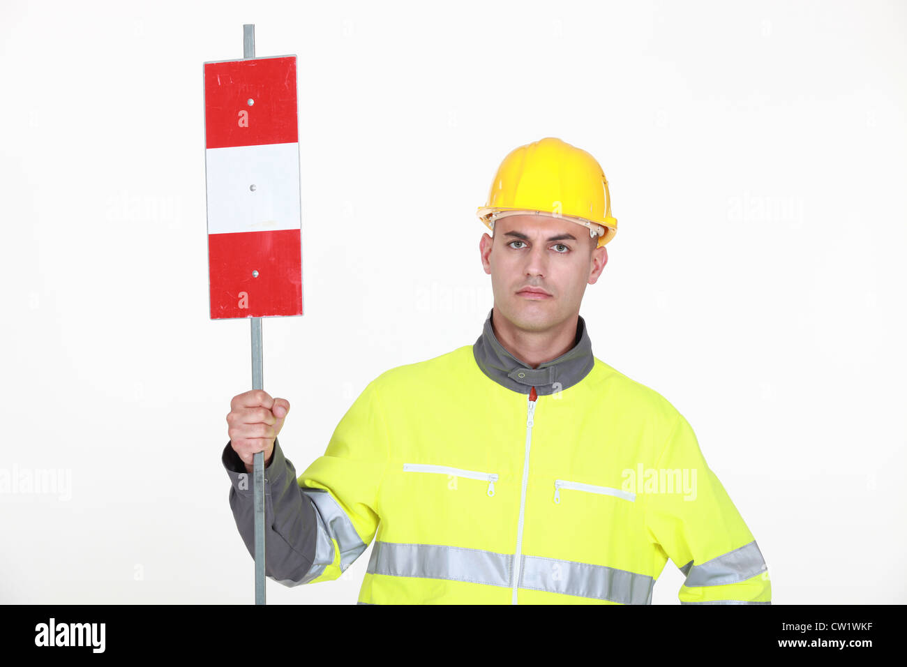 A traffic guard holding up a sign Stock Photo - Alamy