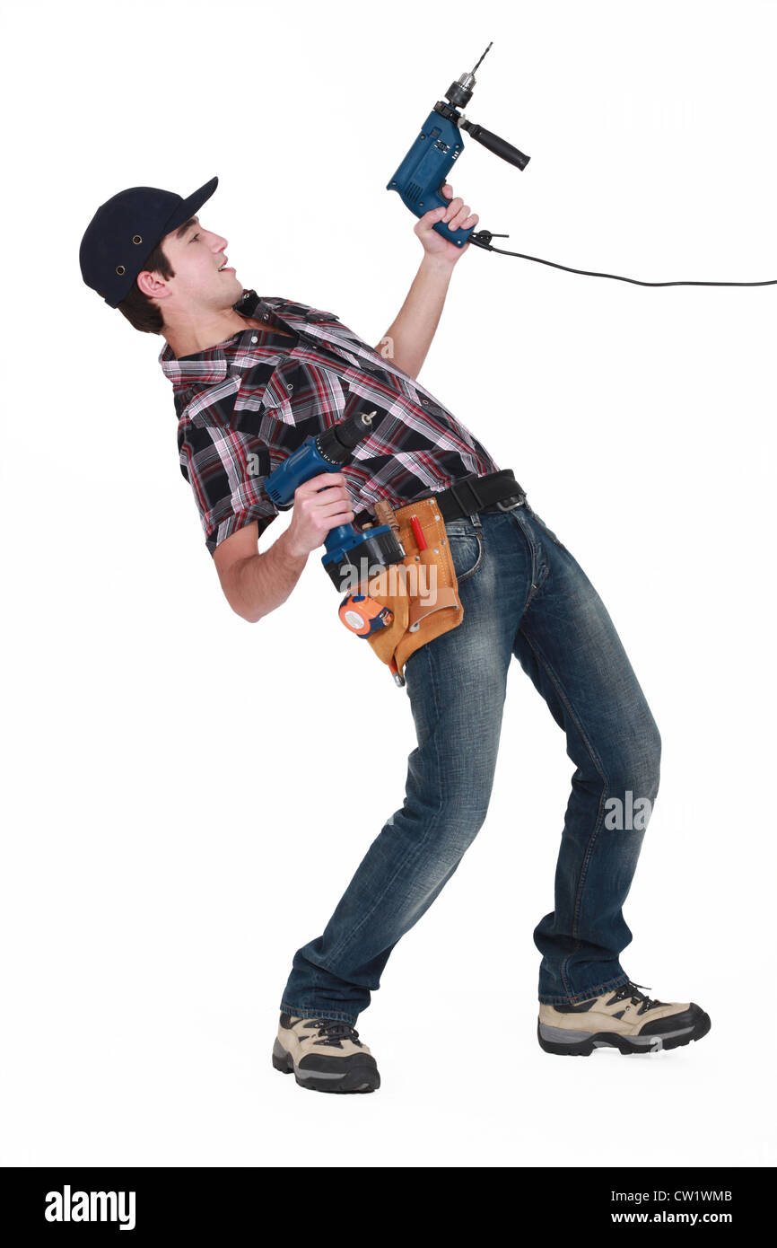 Young man pulling a drill on white background Stock Photo - Alamy