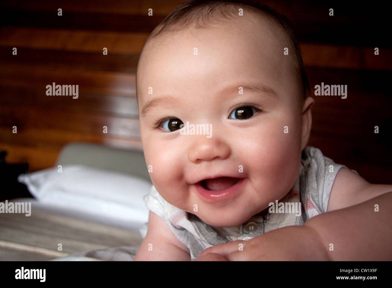Curious and smiling baby girl Stock Photo - Alamy