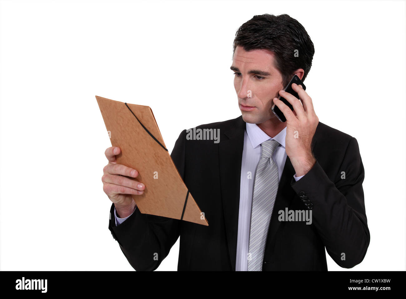Concerned businessman talking on the phone Stock Photo - Alamy