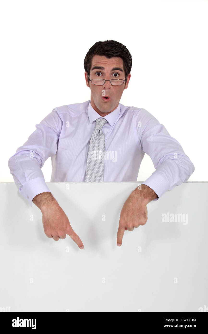 Excited man pointing to a sign Stock Photo - Alamy