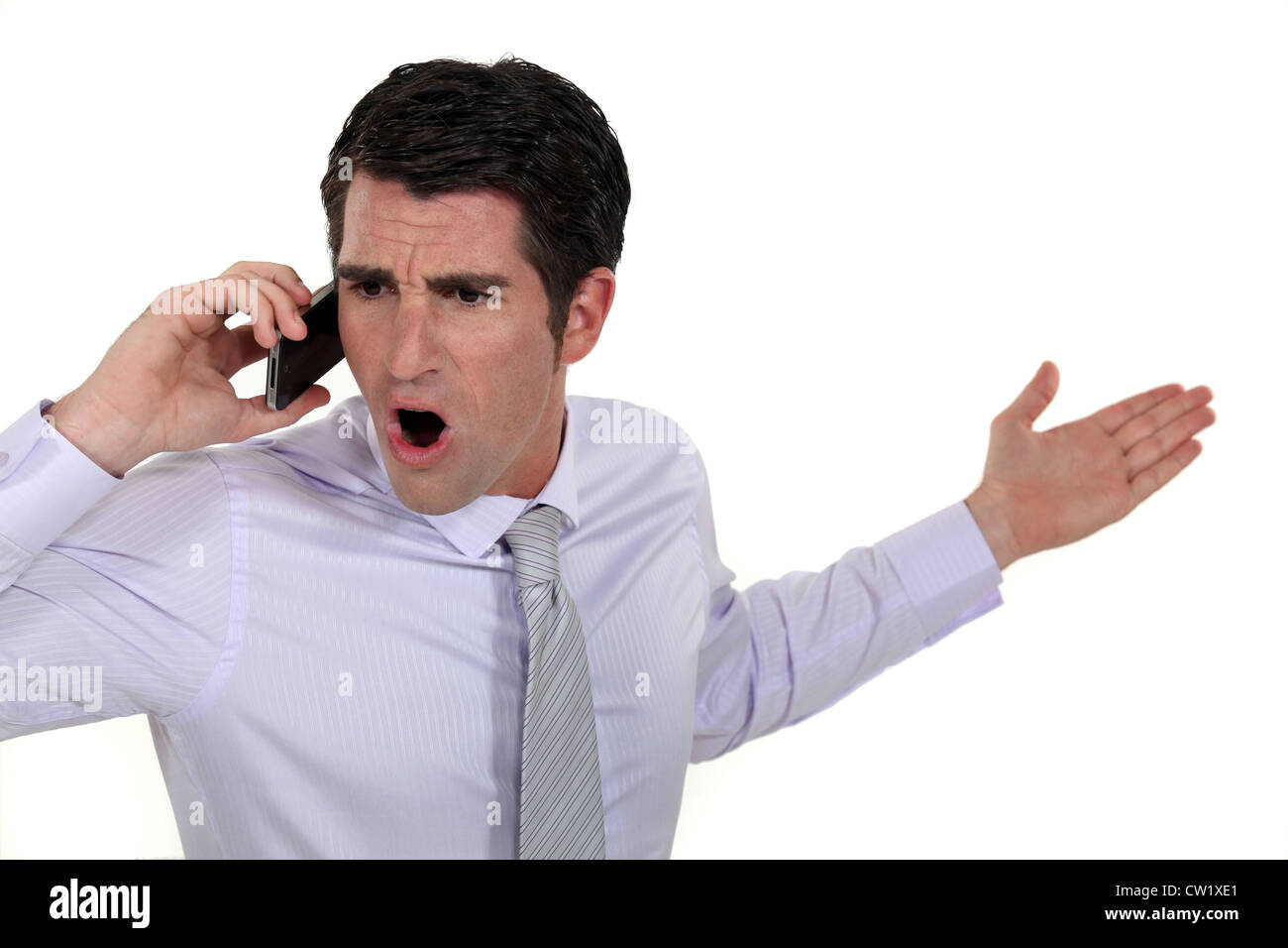angry businessman talking on his cell Stock Photo - Alamy