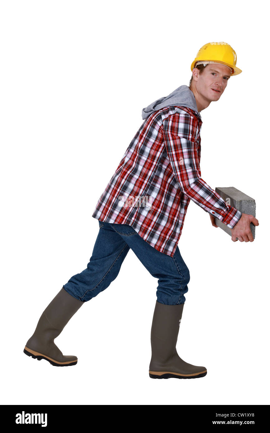 Man carrying heavy brick Stock Photo - Alamy