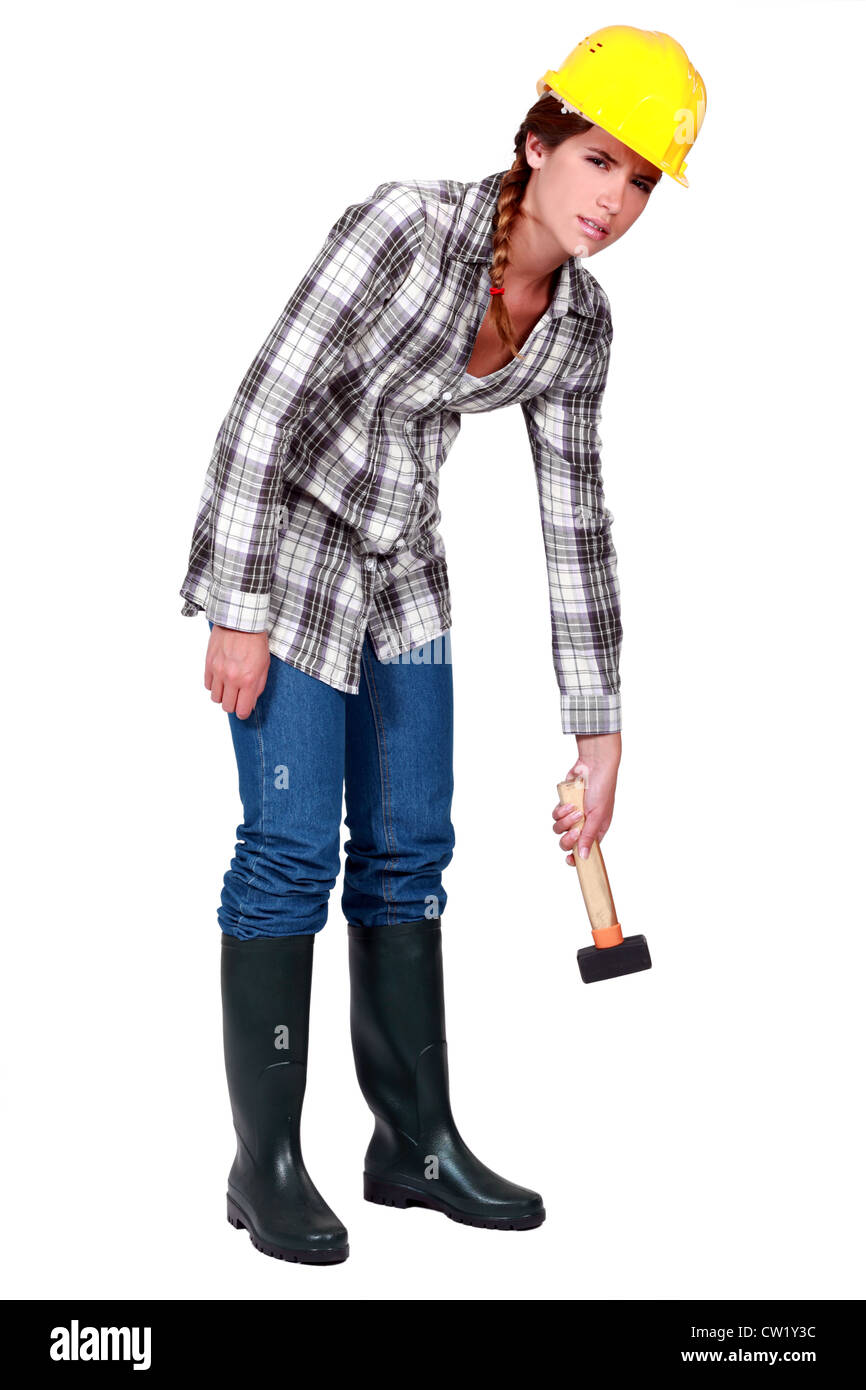 A tired female construction worker with a hammer Stock Photo - Alamy