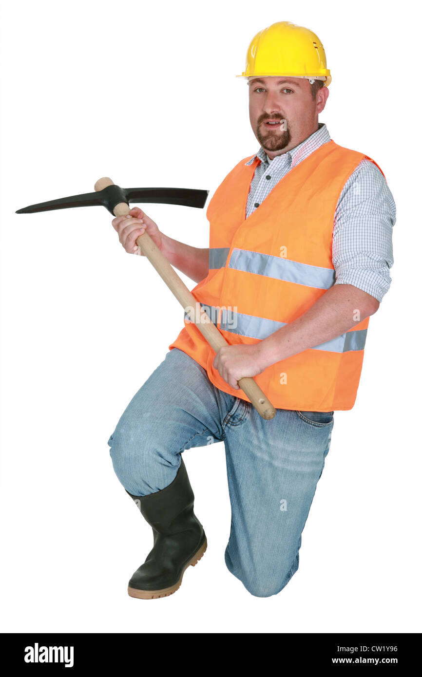 Worker using a pickaxe Stock Photo - Alamy